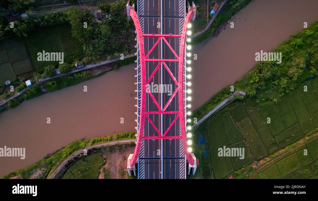 Aerial view of the Kalikuto Bridge, an Iconic Red Bridge at Trans Java Toll Road, Batang when ...