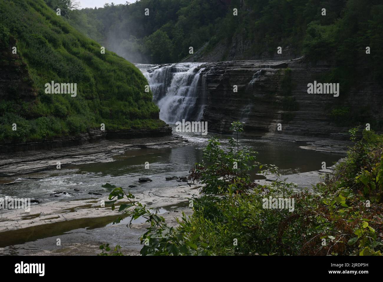 A wonderful waterfall deep in the forest on a gloomy day Stock Photo ...