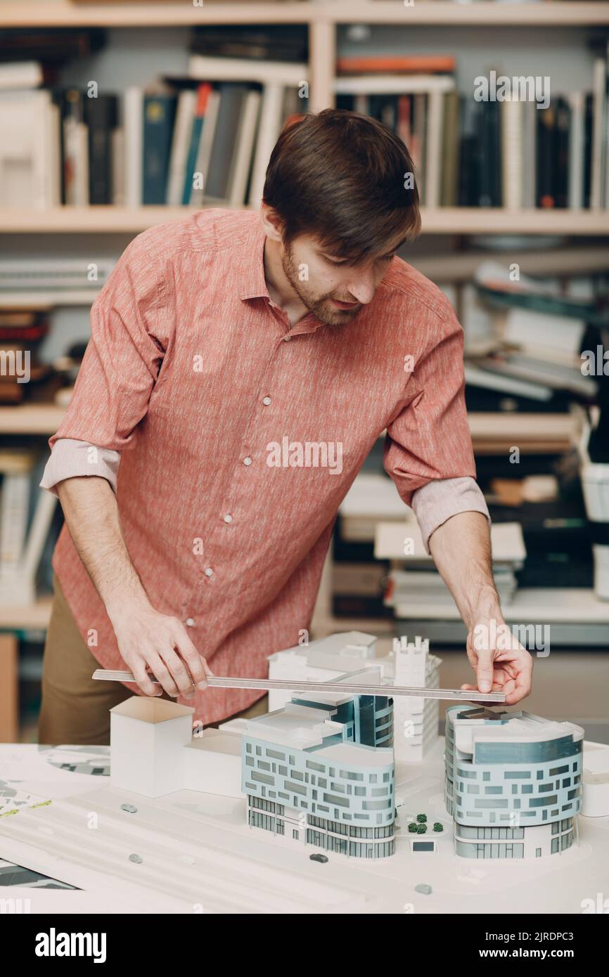 Architect with blueprints and layout buildings house design project at ...