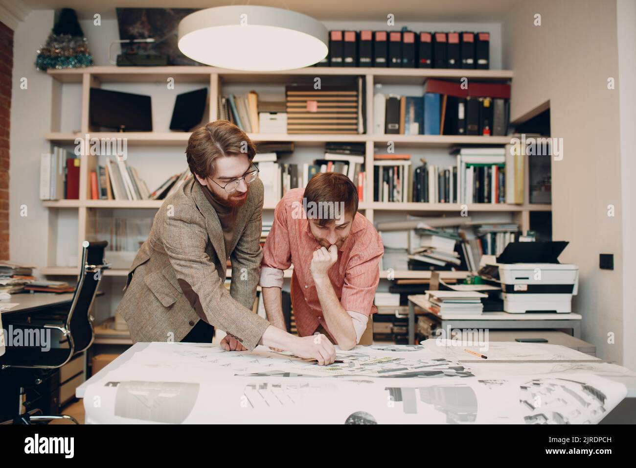 Architect with blueprints and layout design project at office bureau ...