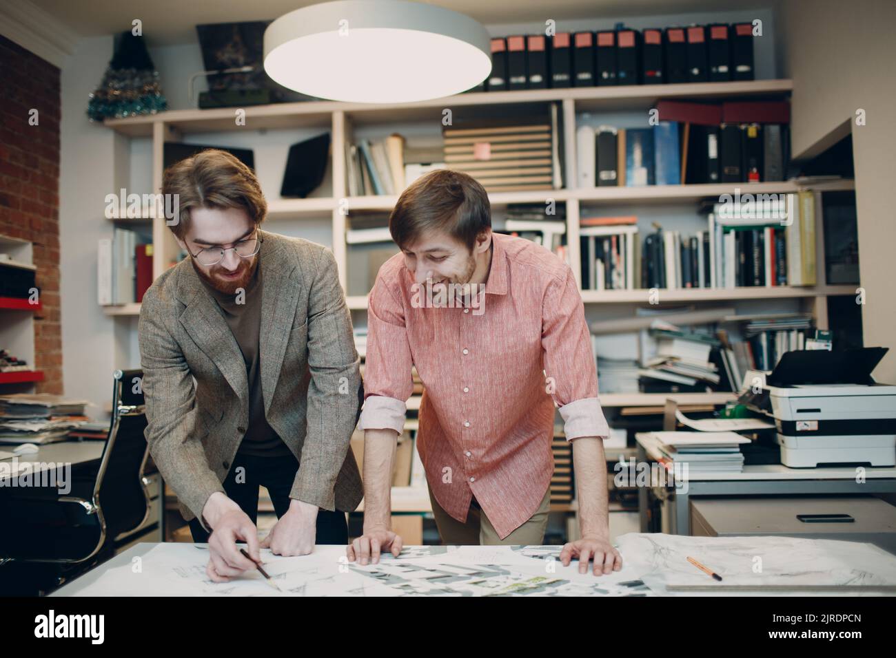 Architect with blueprints and layout design project at office bureau ...