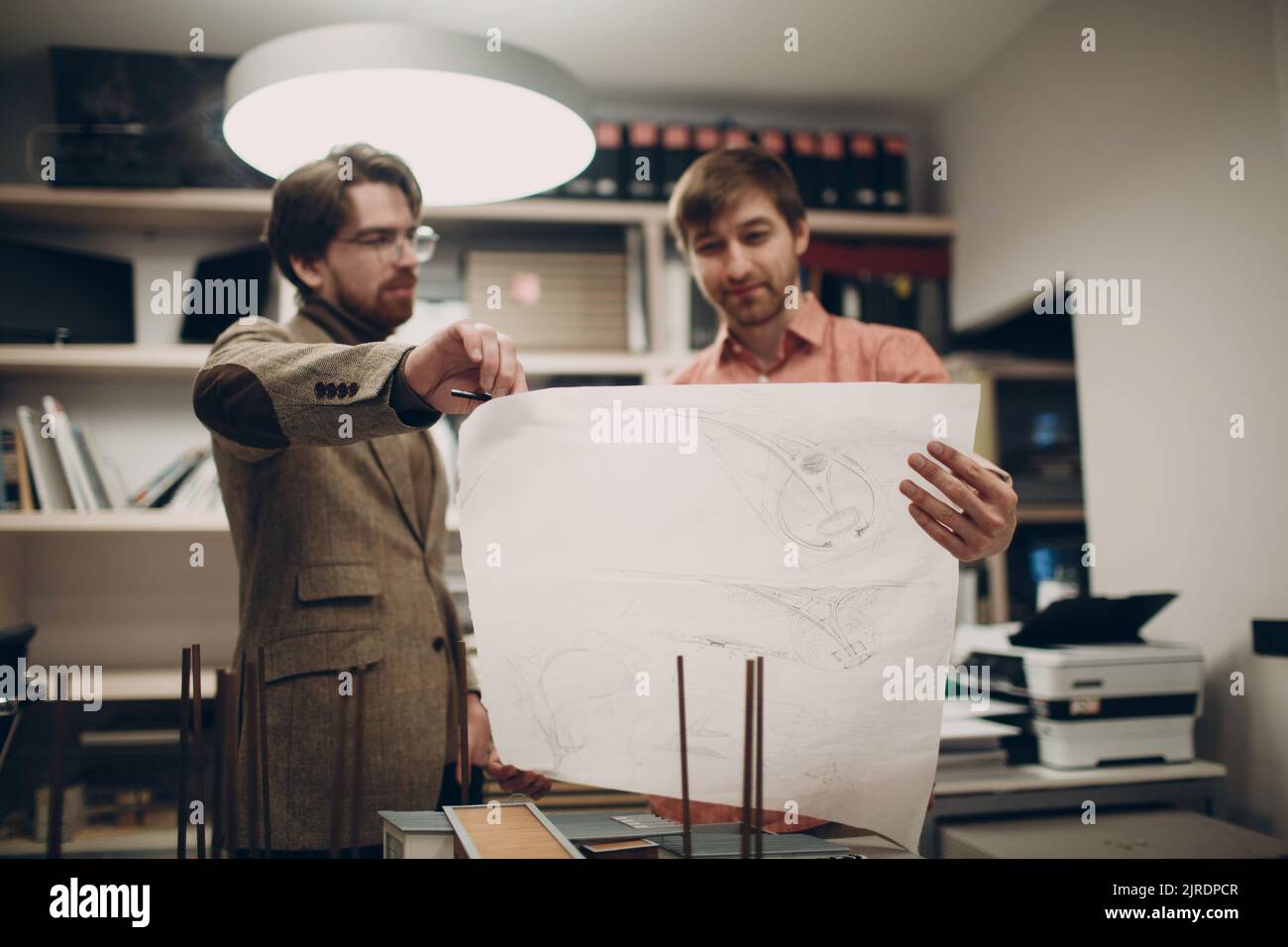 Architect with blueprints and layout design project at office bureau ...