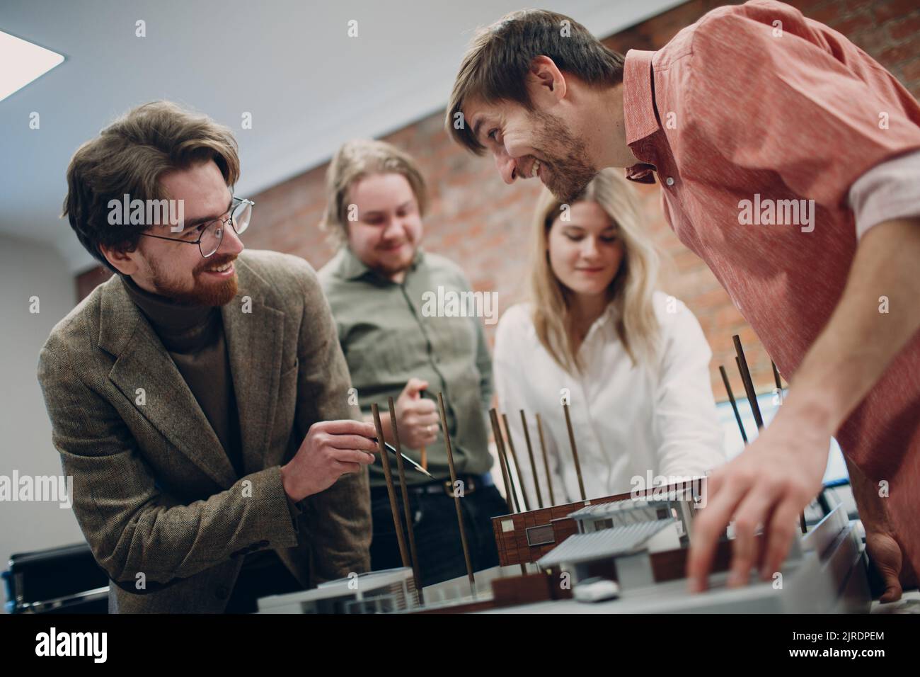 Architect team with blueprints and layout design project at office ...