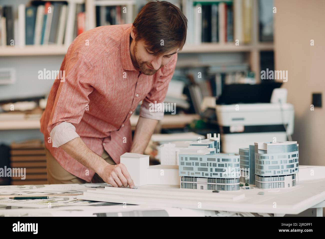 Architect with blueprints and layout design project at office bureau ...