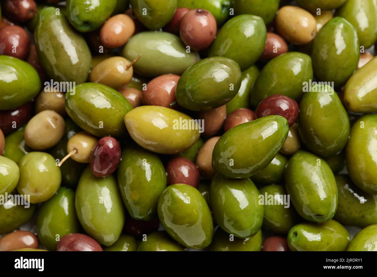 Mixed olives in brine. Food background, close up view Stock Photo - Alamy