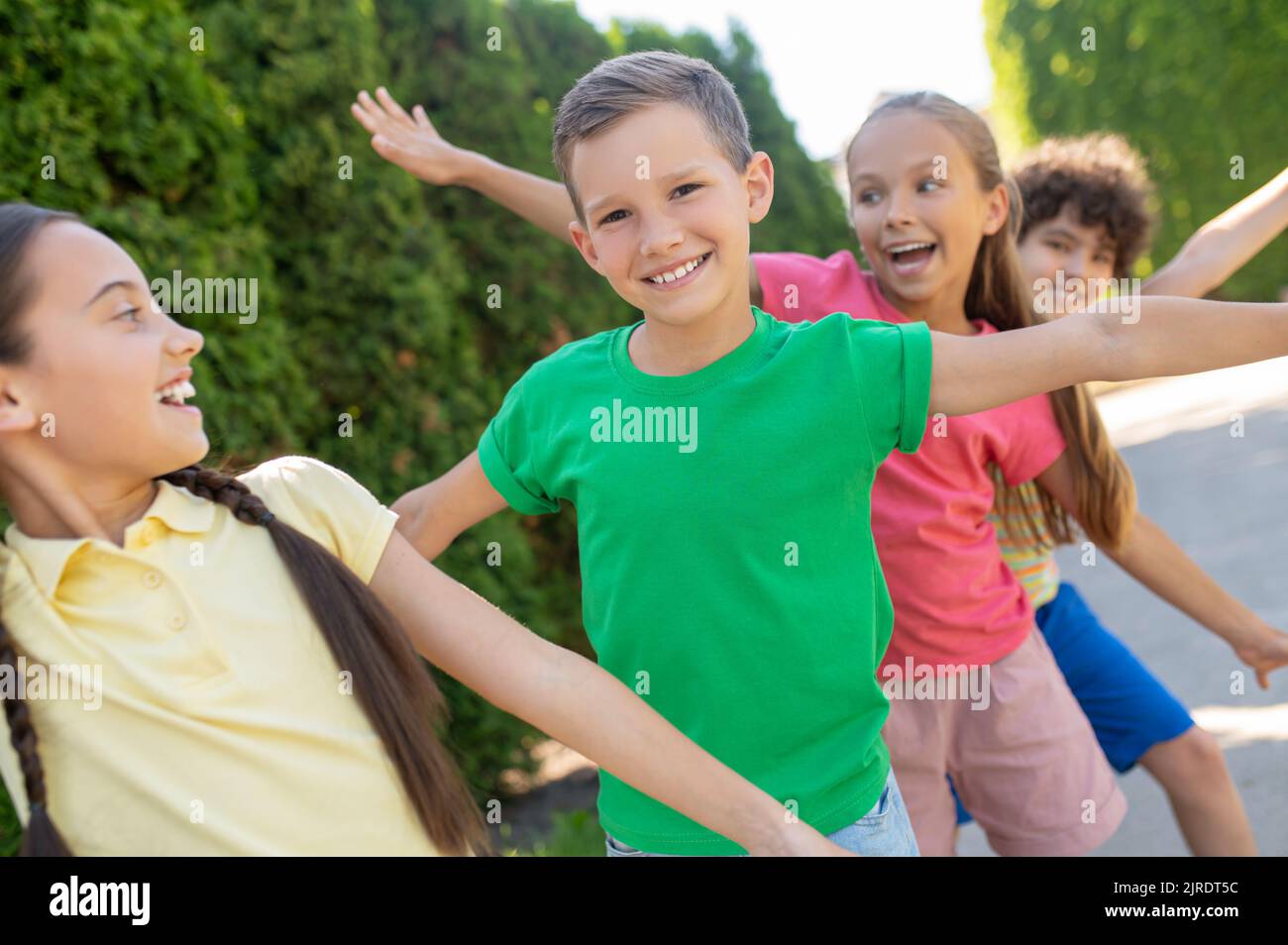Happy children playing together in park Stock Photo - Alamy