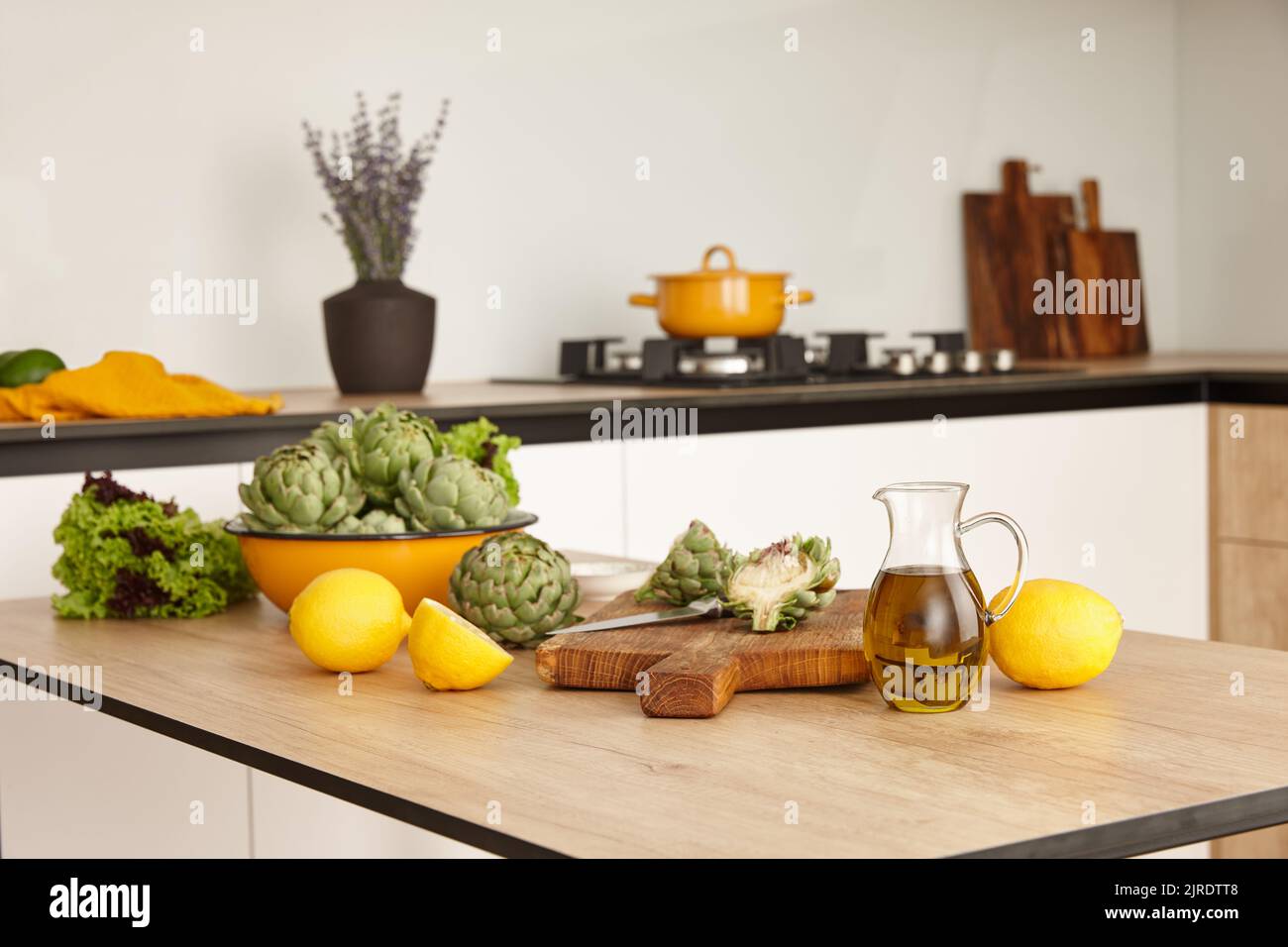 Cooking green artichokes in the kitchen, interior background Stock ...