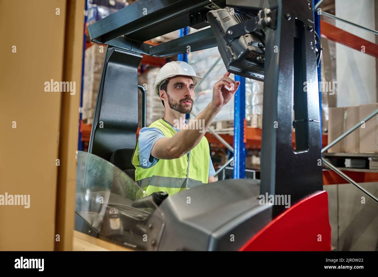 Experienced focused lift truck operator working in the warehouse Stock ...