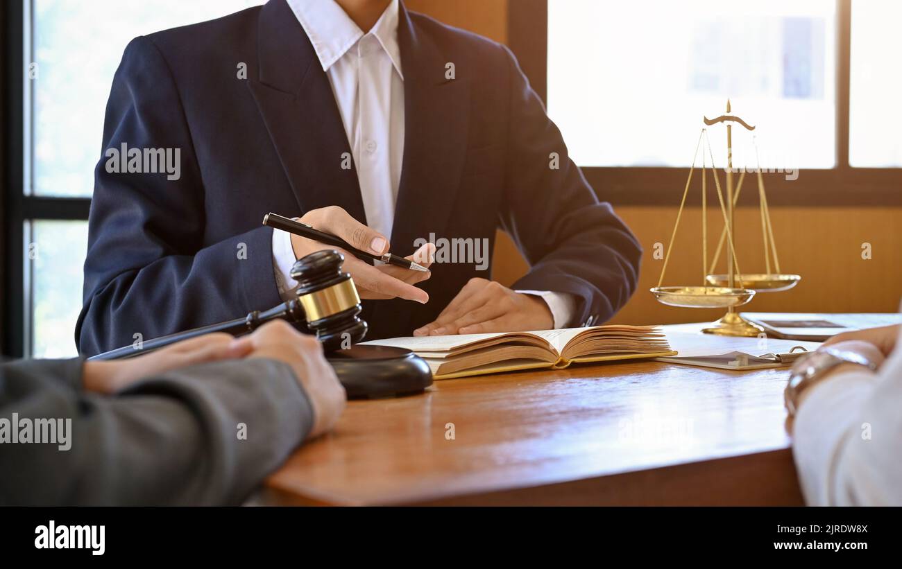 A professional male lawyer in a formal suit is giving advice and ...