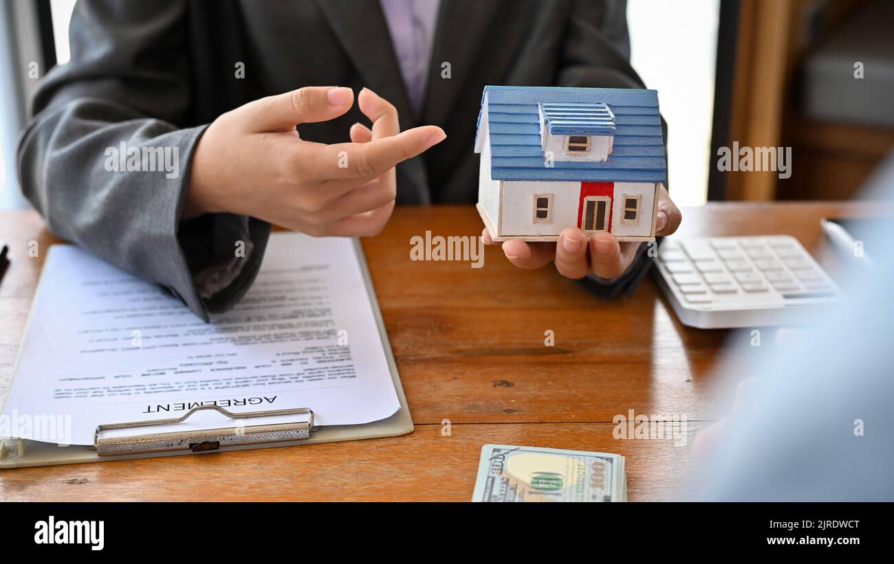 A professional male real estate agent meeting with his client in the ...