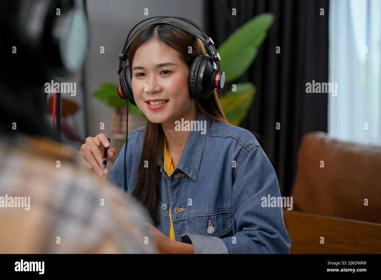 Confident Young Asian Female Radio Host Or Podcast Content Creator Is