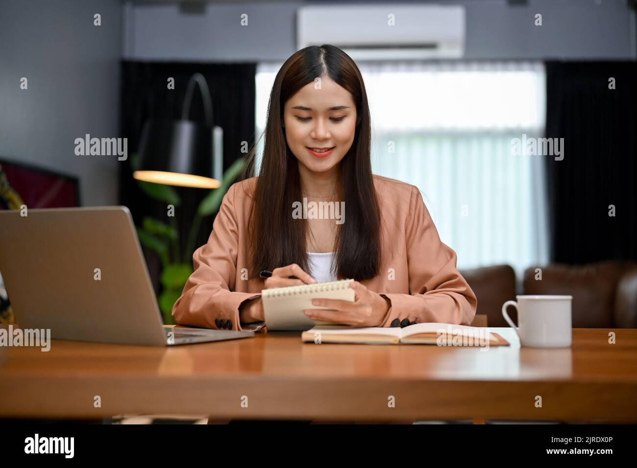 Beautiful and attractive young Asian businesswoman or female employee ...