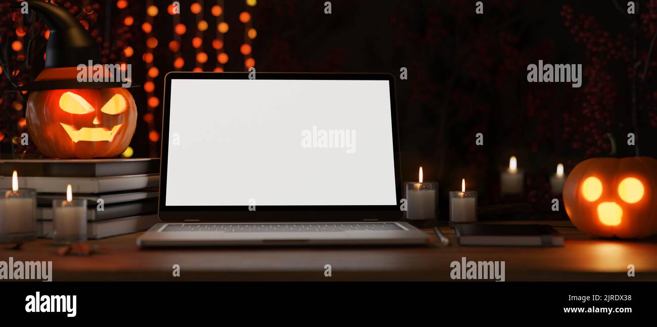 Modern dark working space or office desk with halloween decor, laptop ...
