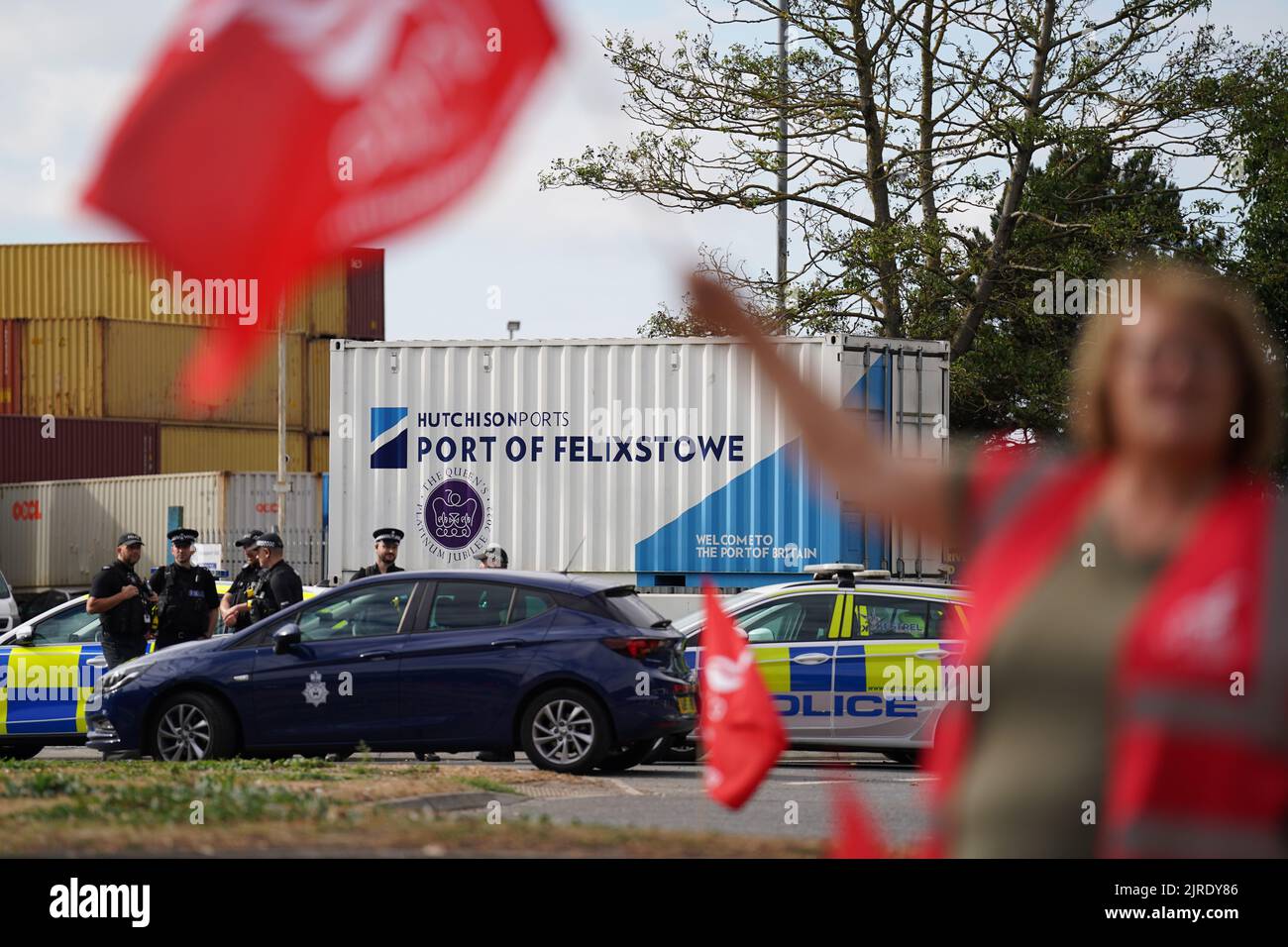 Police watching members of the Unite union man a picket line at one of ...