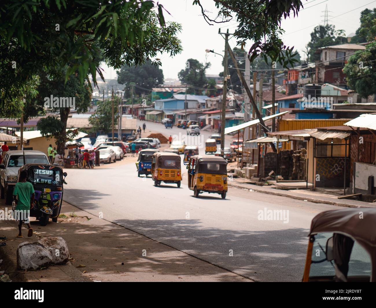 A busy street and residential buildings of central Monrovia in Liberia ...
