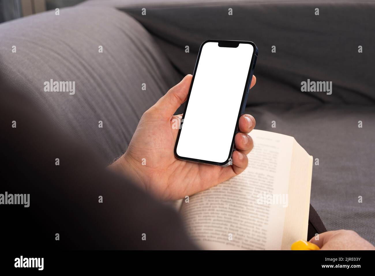 Holding mobile phone, over shoulder view of man hand holding mobile ...