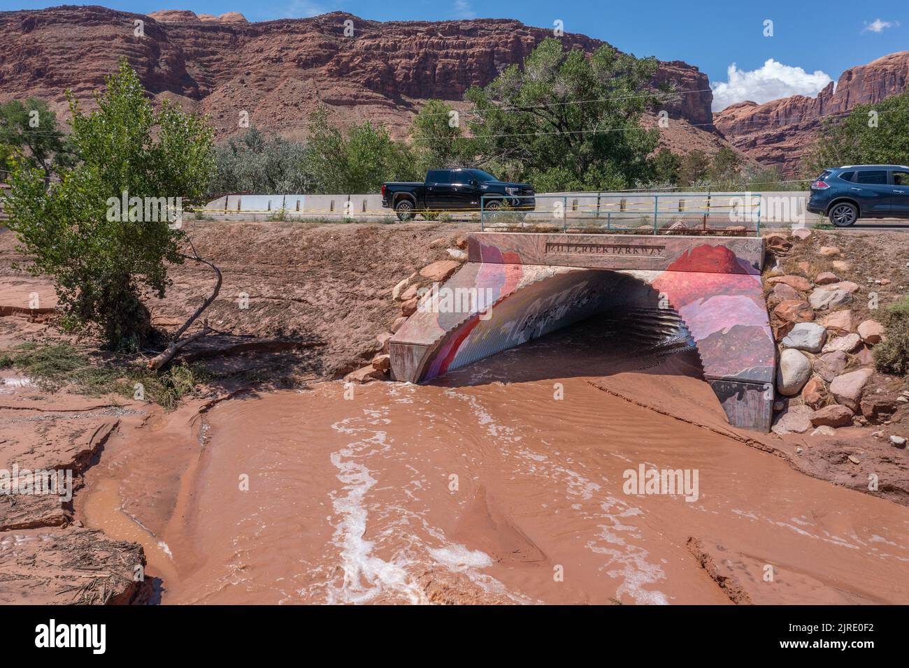 Low drone view of receding flood waters still flowing over the flooded ...