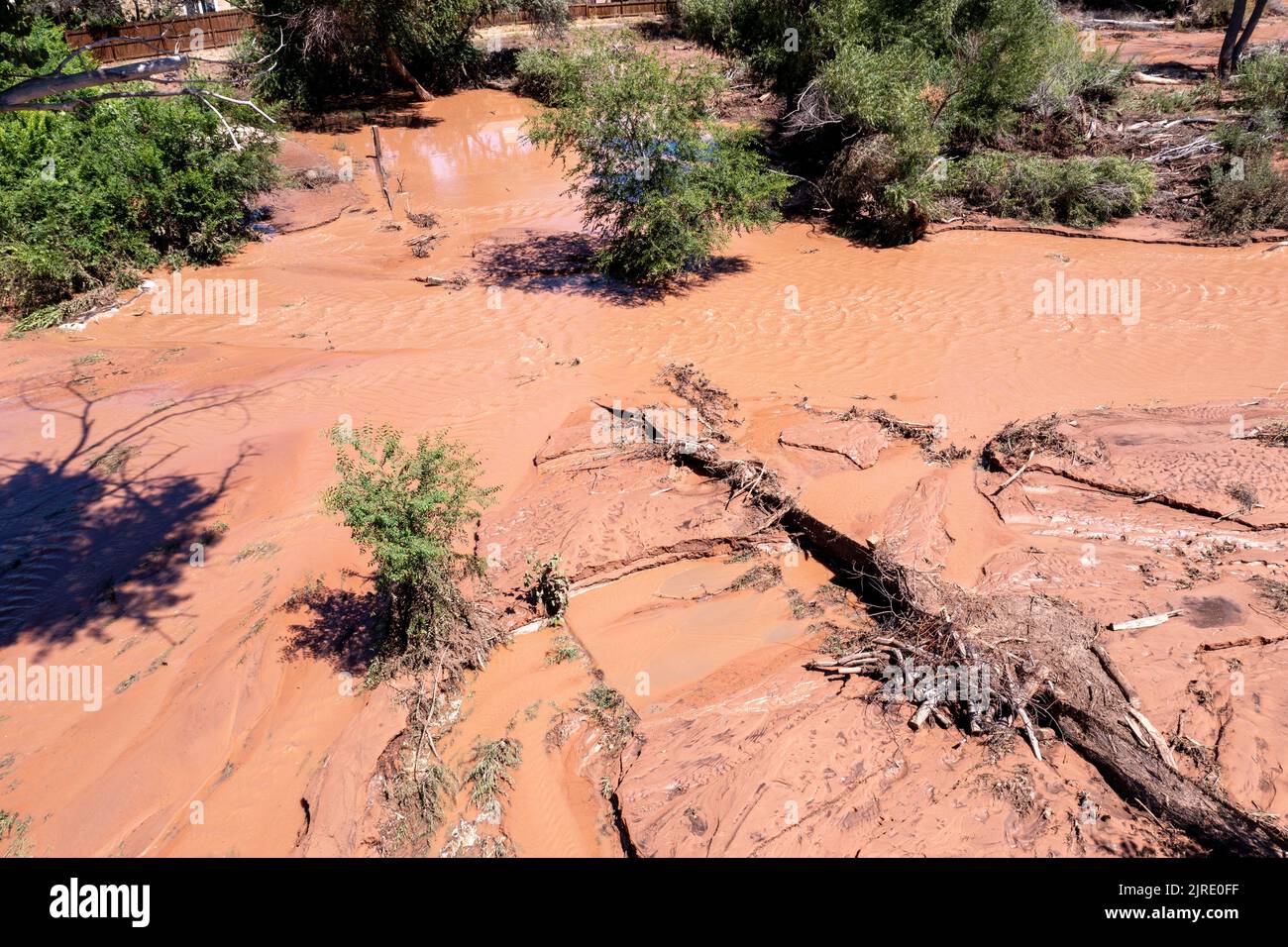 Aerial view of receding flood waters still flowing over the flooded ...