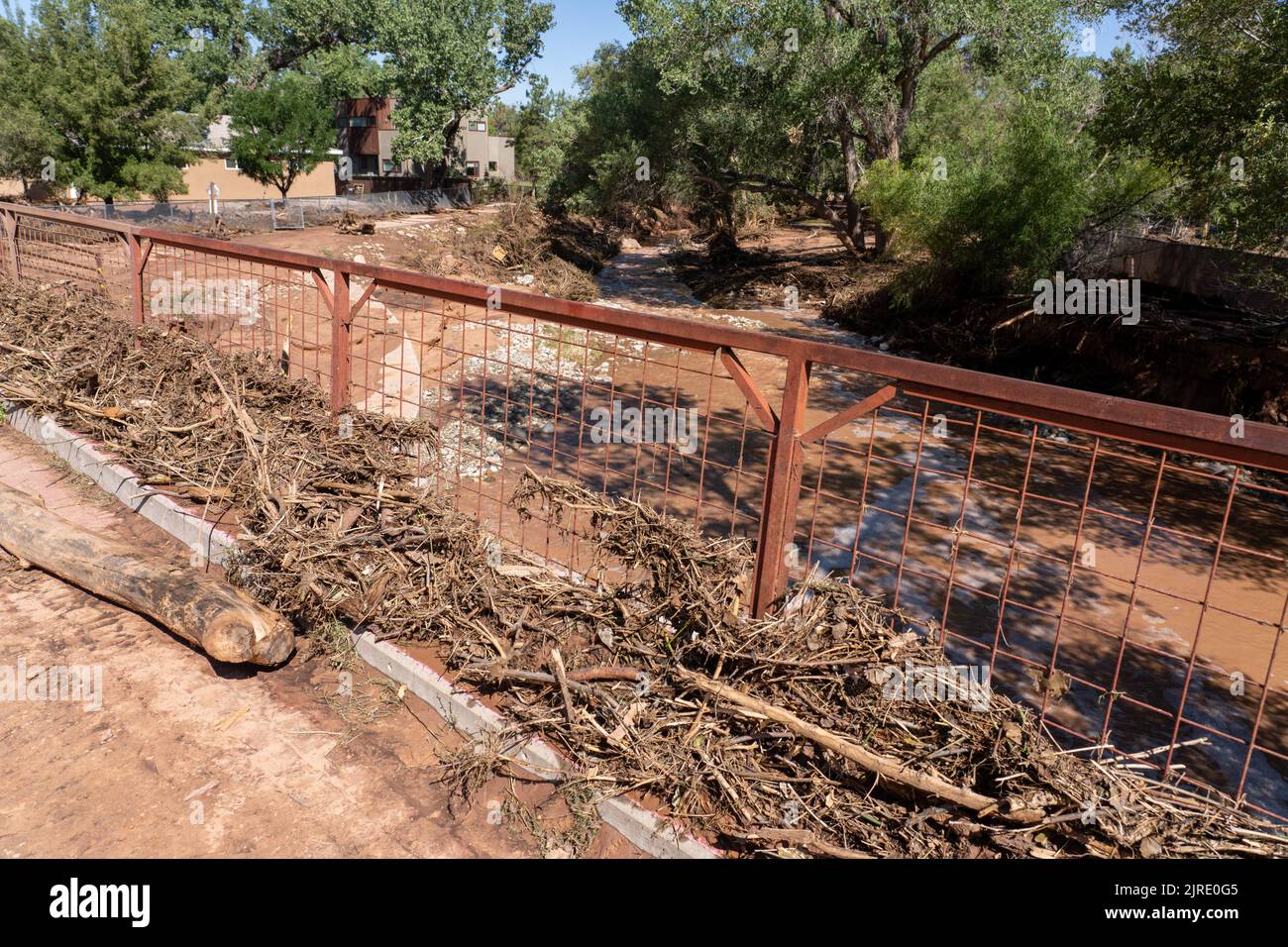 Debris trapped against a bridge guardrail over the MIll Creek Parkway ...