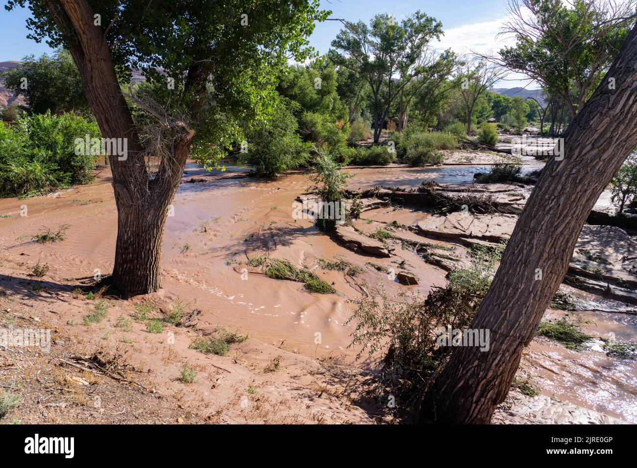 Receding flood waters still flowing over the flooded Mill Creek Parkway ...