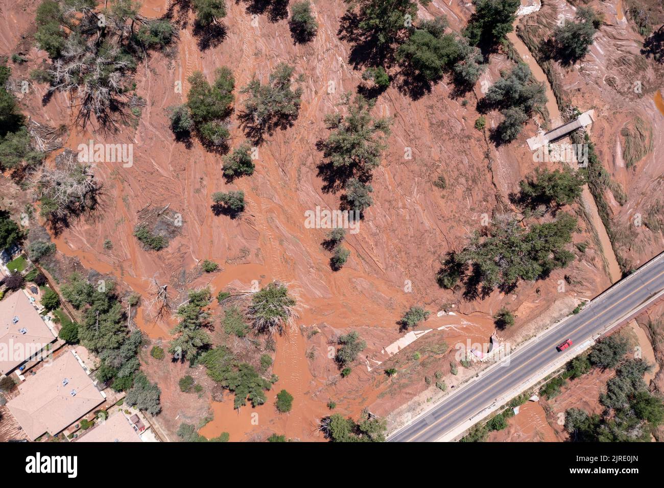Aerial view of receding flood waters still flowing over the flooded ...