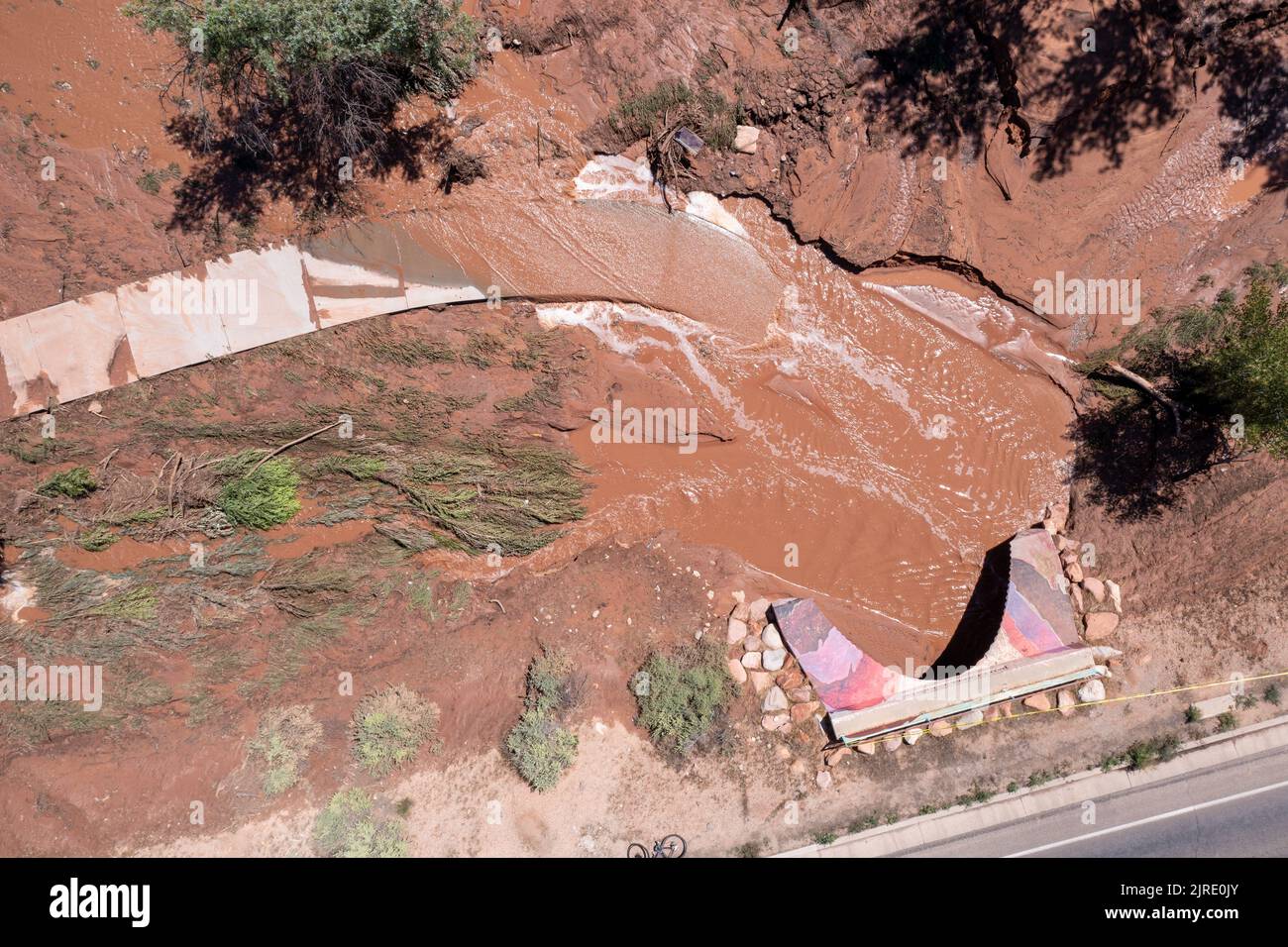 Aerial view of receding flood waters still flowing over the flooded ...
