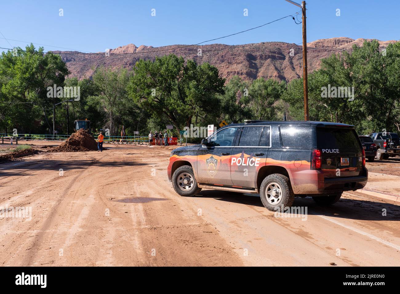 A police car blocks the street so mud can be cleaned up after a flash ...