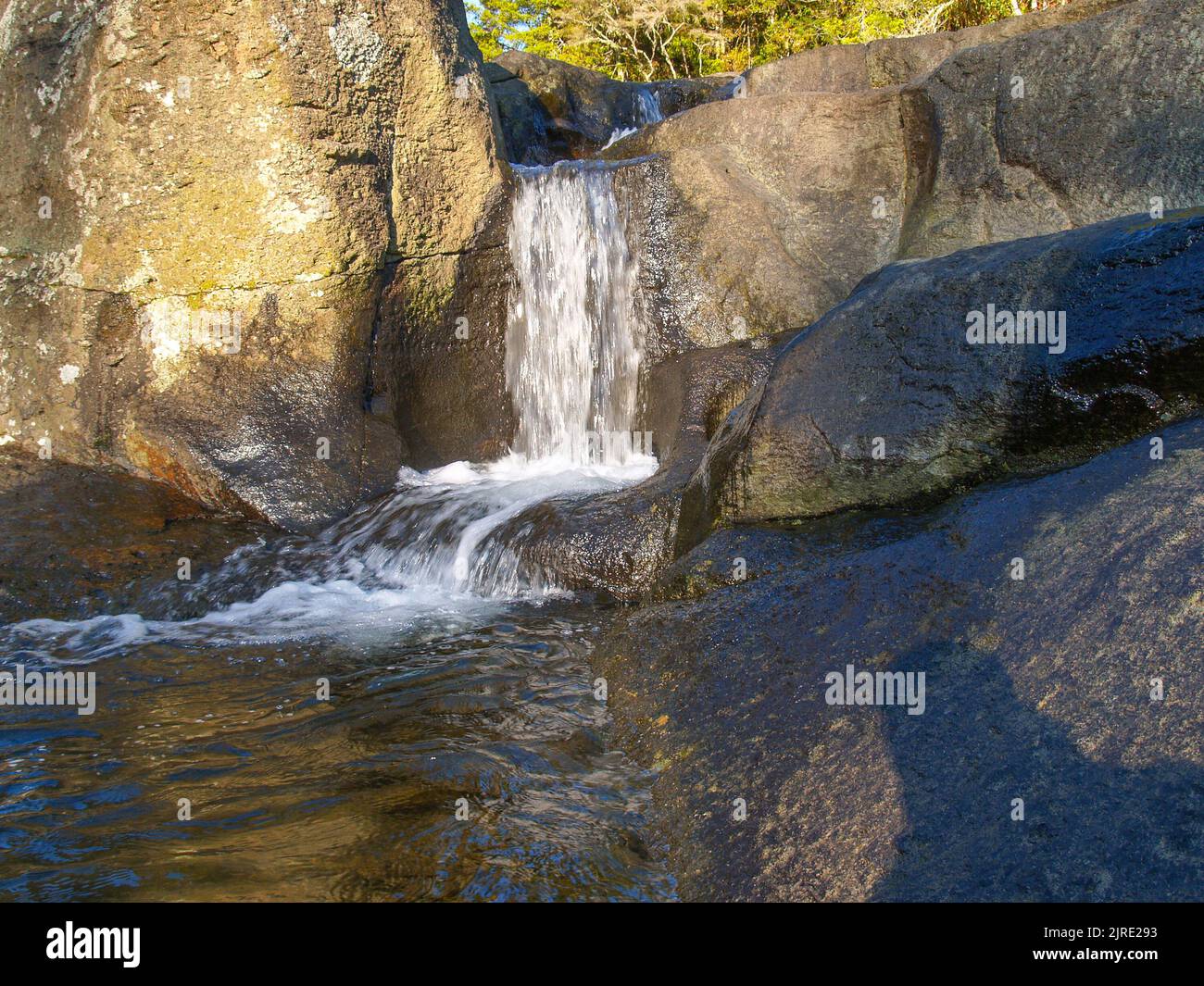 Stream and waterfall over rocks at McLaren Falls Park and Lake Stock ...
