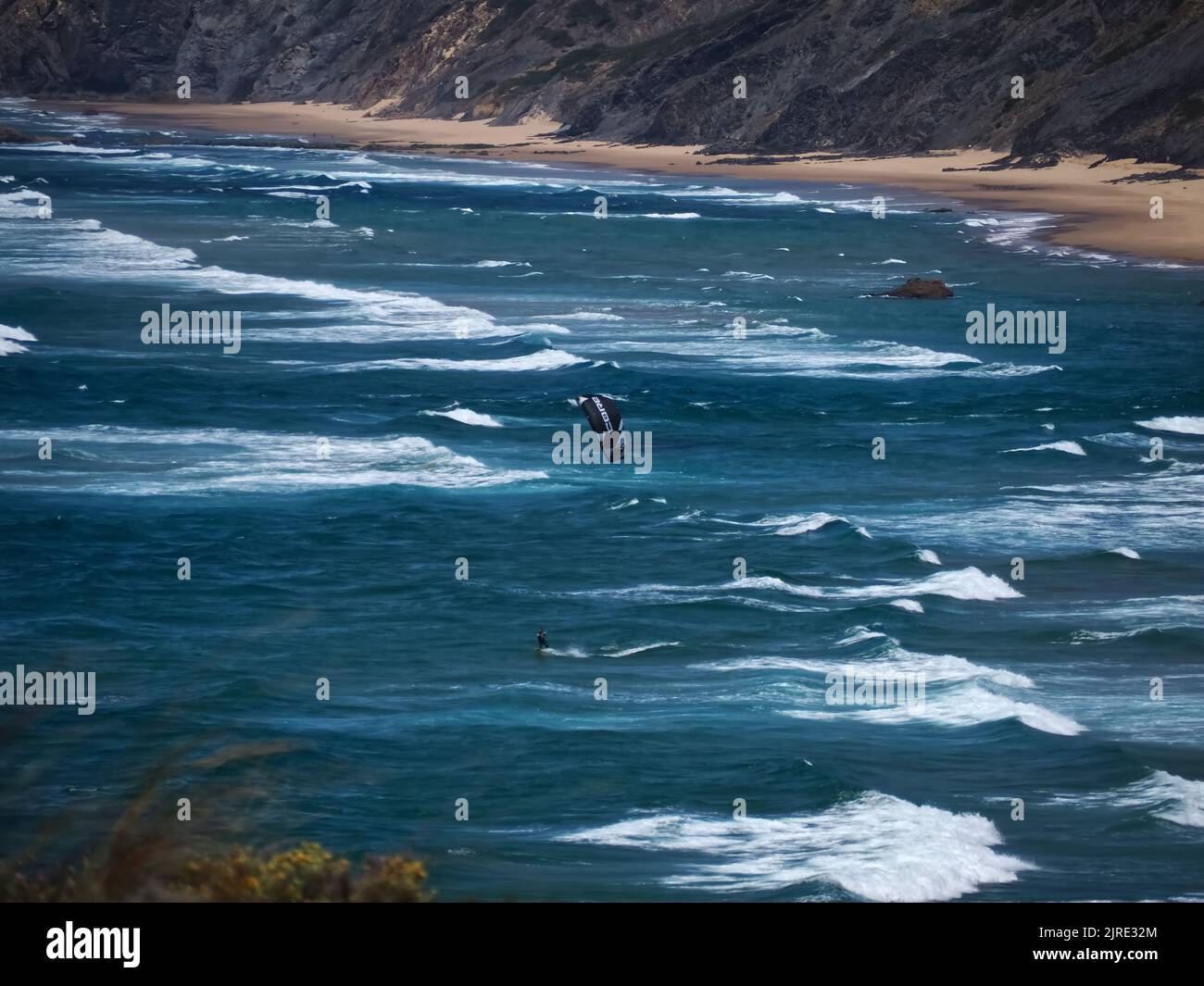 Core surfer and kite surfing umbrella in black and white at the beach ...