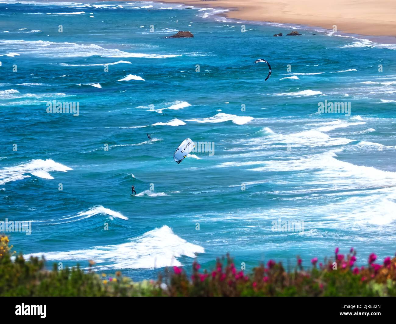 Core surfer and kite surfing umbrella in black and white at the beach ...