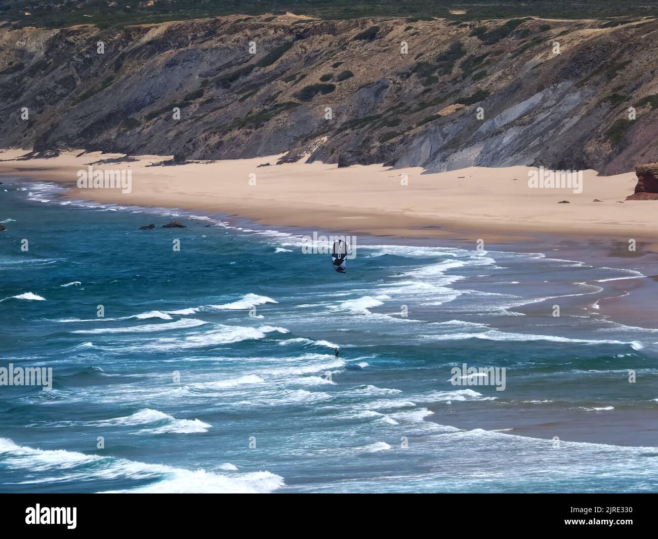 Core surfer and kite surfing umbrella in black and white at the beach ...