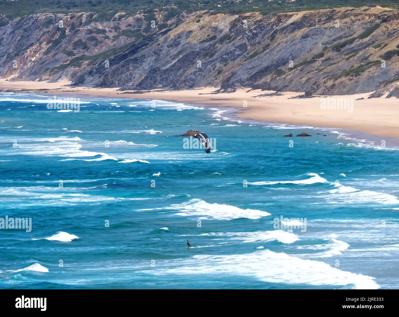 Core surfer and kite surfing umbrella in black and white at the beach ...