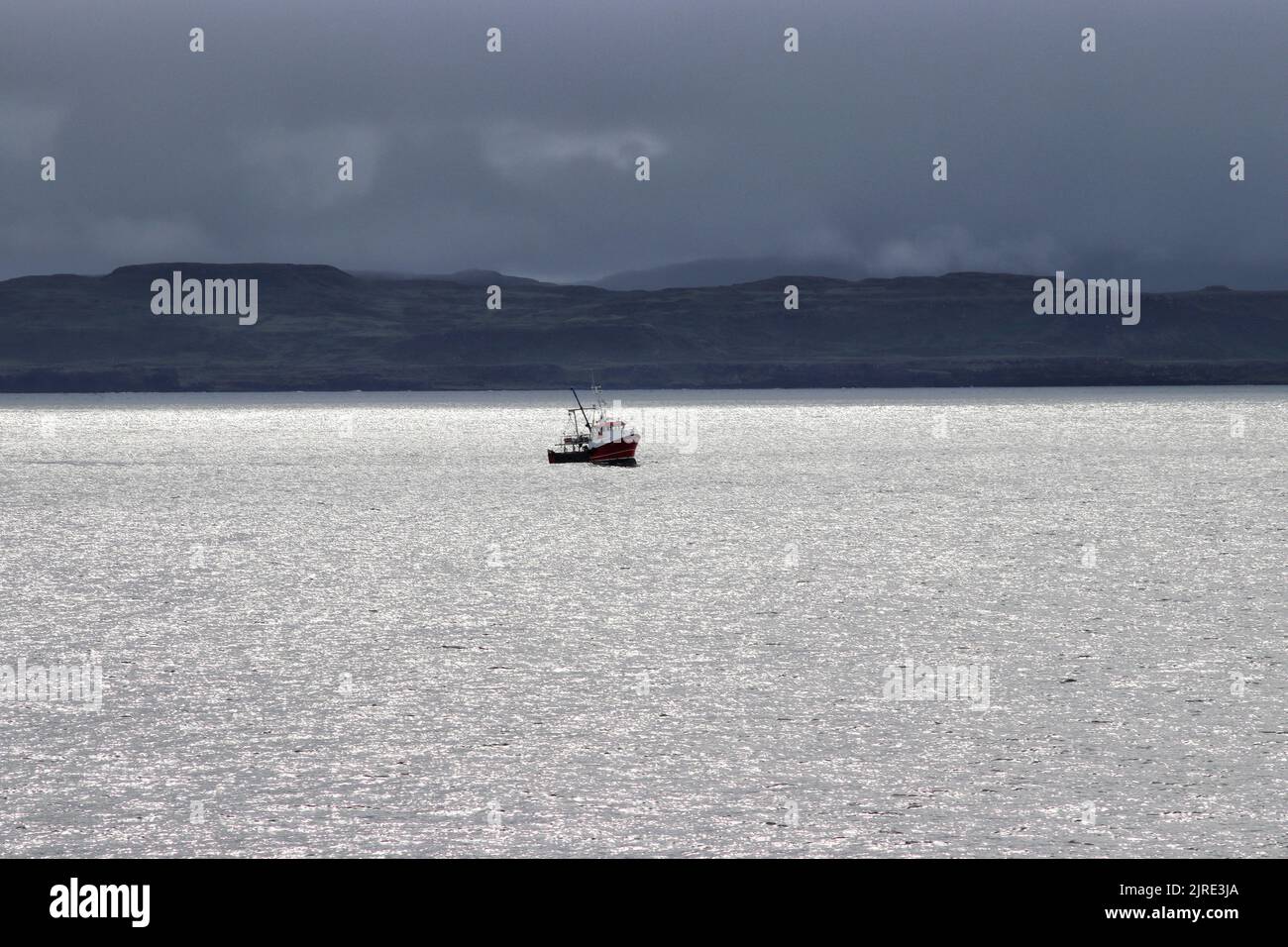 Fishing boat and island Stock Photo - Alamy