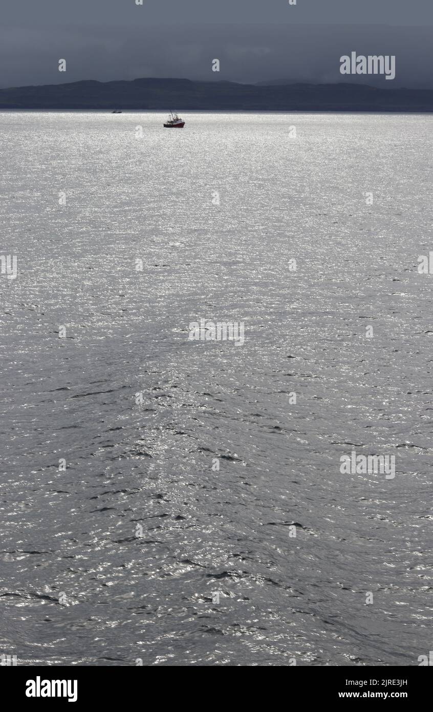 Fishing boat and island Stock Photo - Alamy
