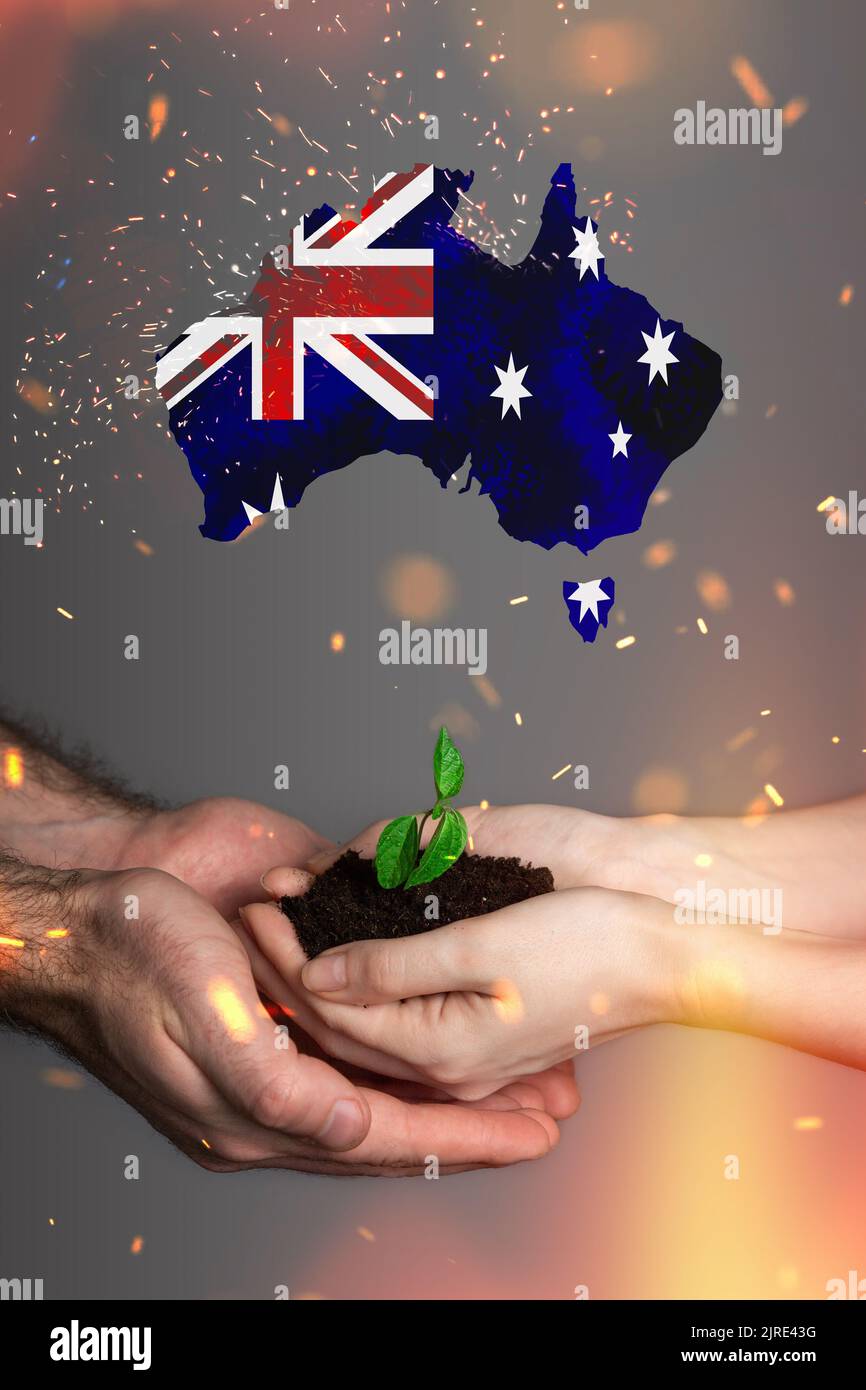 Pray For Australia. The hands of a man and a woman hold the soil with a ...