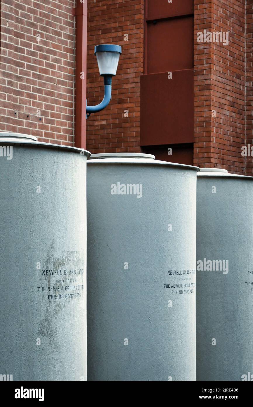 A vertical shot of commercial liquid storage units located next to a ...