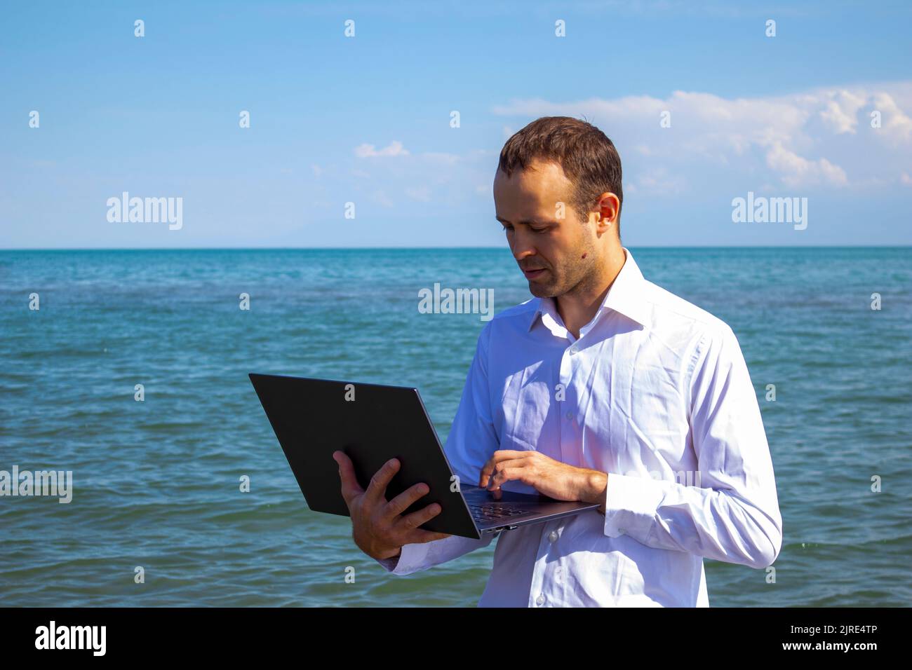 Man in white shirt typing hi-res stock photography and images - Alamy