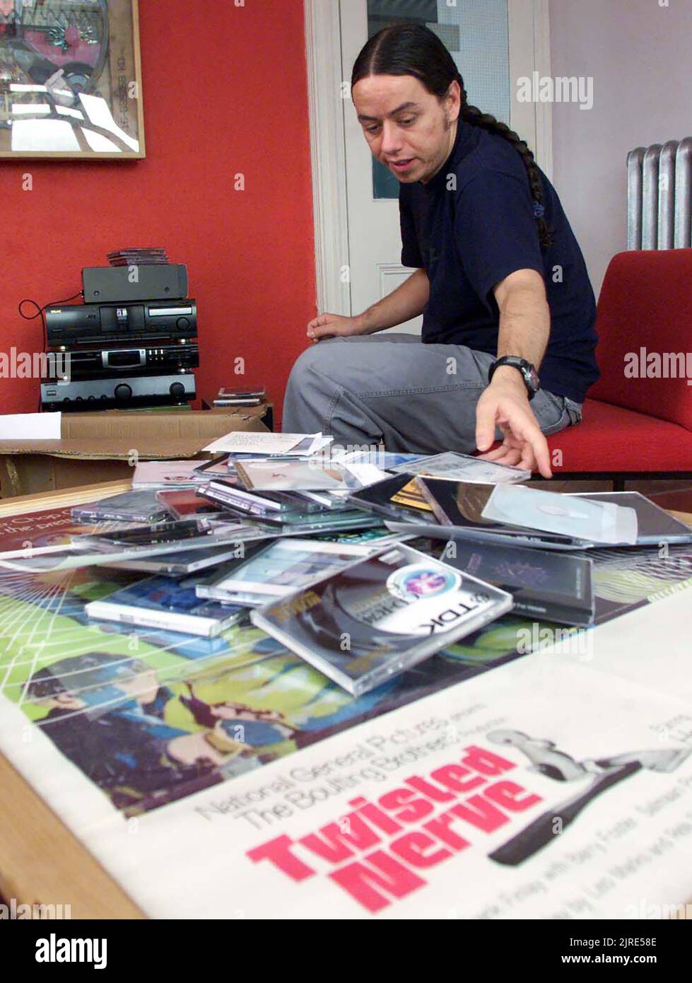 PAUL VELLA SORTS DEMO TAPES/CDS AT TWISTED NERVE OFFICE . ( FOREGROUND ...