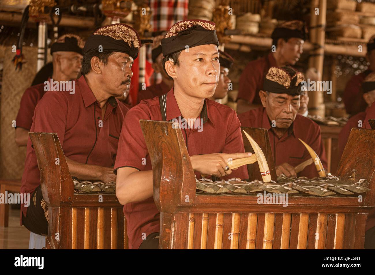 Men play a gamelan music by beating hammers on tuned plates Stock Photo ...