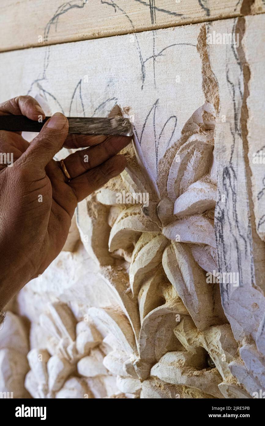 Man carves details into a large marble mosaic commissioned by a client ...