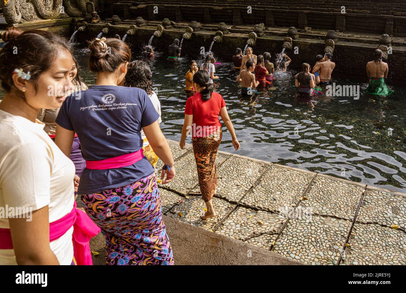 People receive blessing at the Water Temple in Bali aka Tirta Empul ...