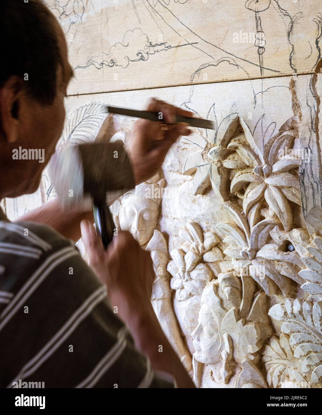 Man carves details into a large marble mosaic commissioned by a client ...