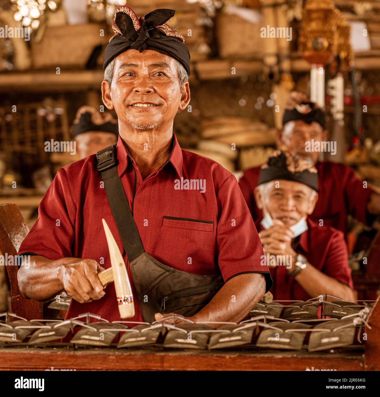 Men play a gamelan music by beating hammers on tuned plates Stock Photo ...