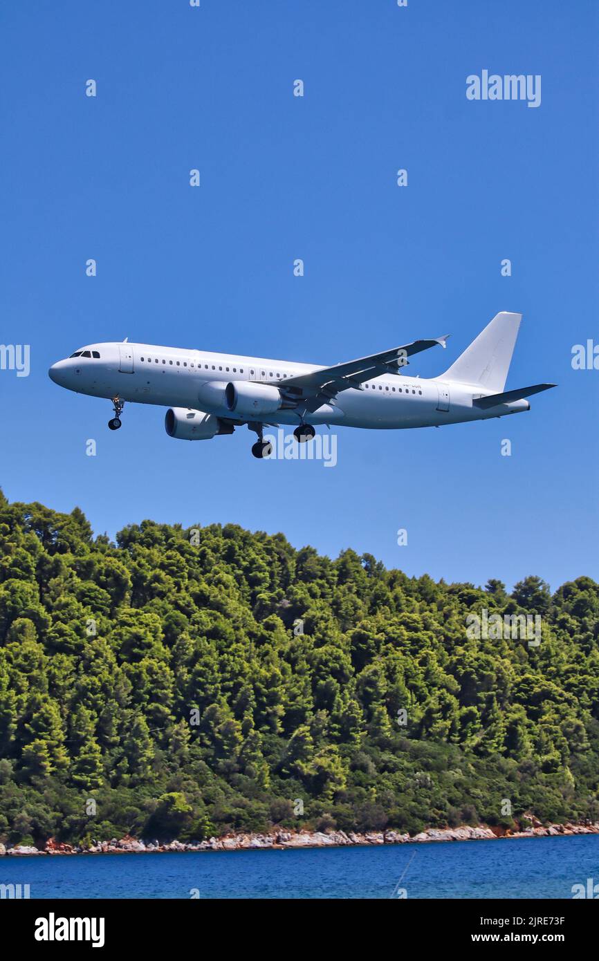 A vertical shot of an A320 landing at Skiathos Airport in Greece Stock ...