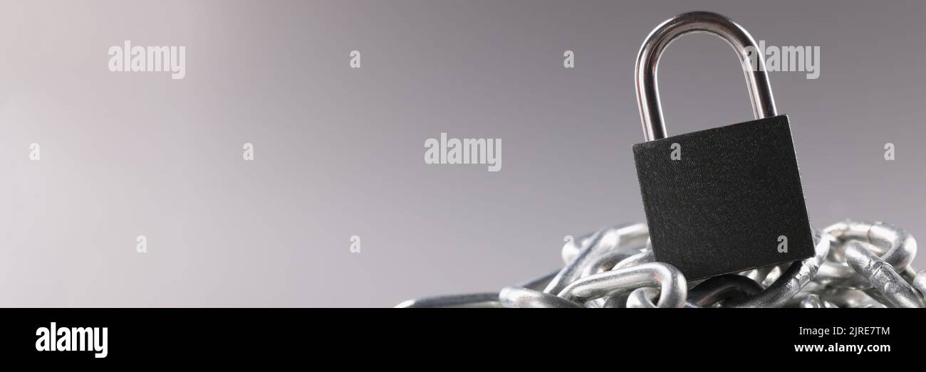 Solid metal locked padlock on top of tangled silver chain Stock Photo ...