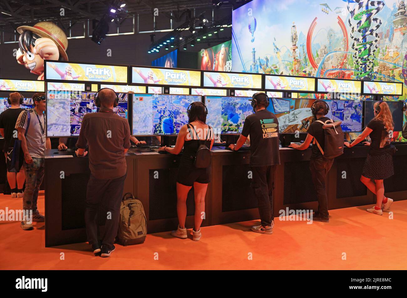 Cologne, Germany. 24th Aug, 2022. Fair visitors test a computer game ...