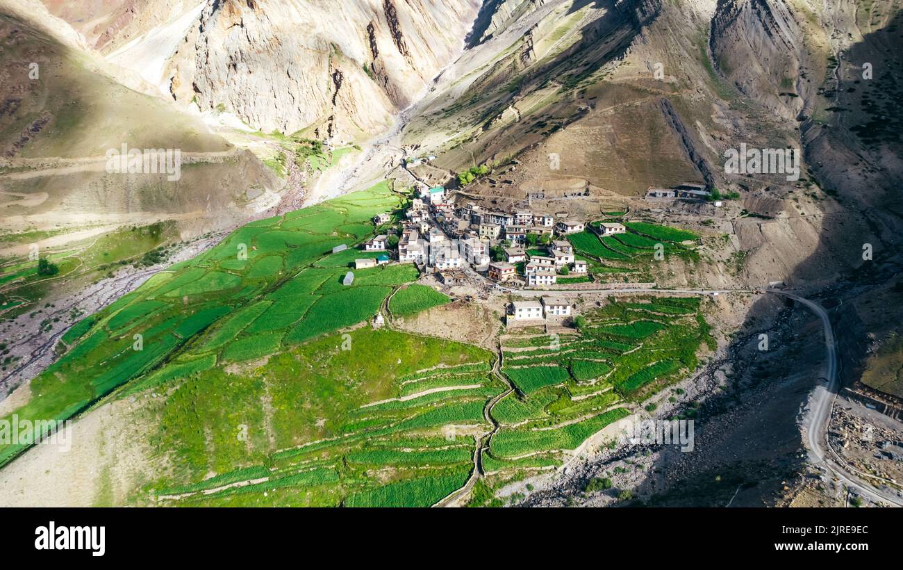 Aerial top down of small Mud Village surrounded by extreme mountain ...