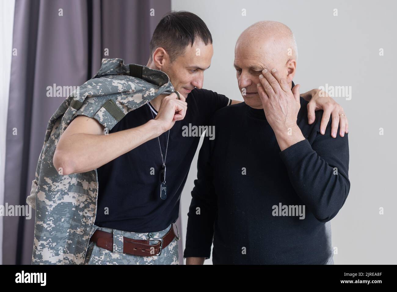 Portrait of army man with parents, elderly father and military son ...
