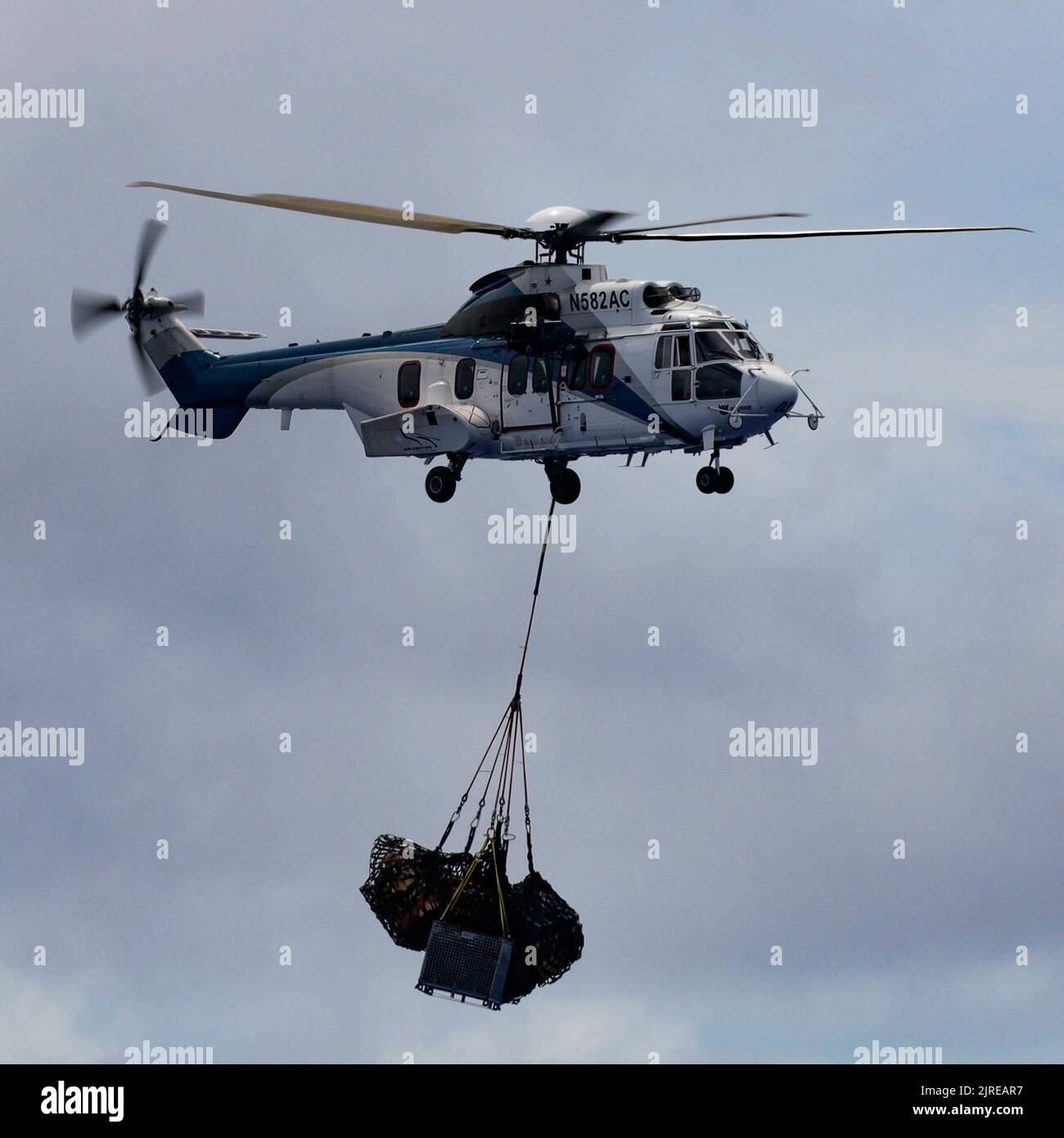 An EC-255 Super Puma with the Maritime Pre-Positioning Force lifts ...