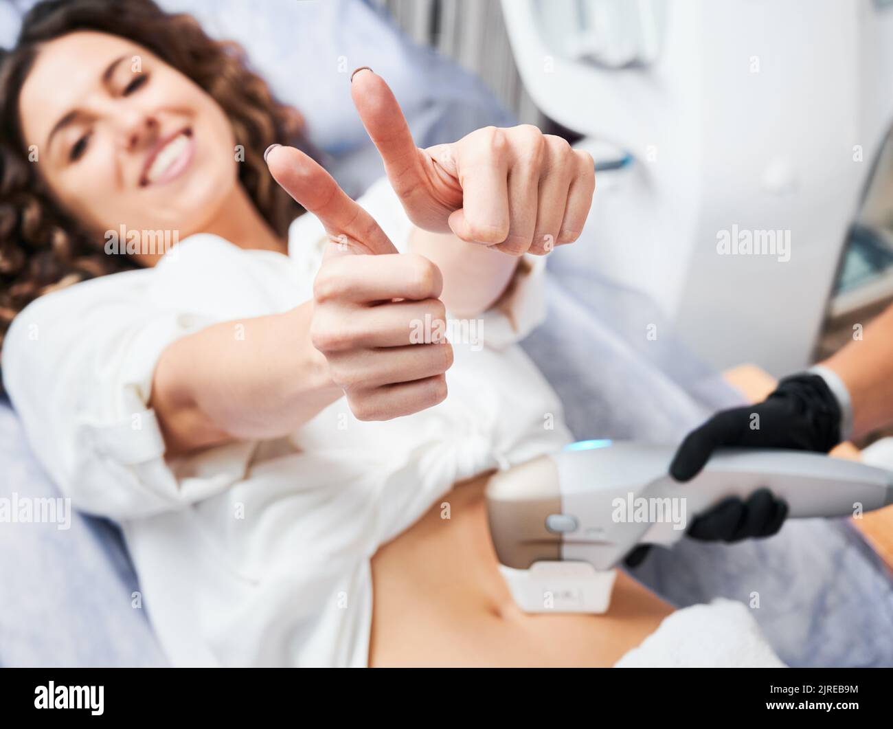 Young satisfied patient with joyful face expression showing thumbs up ...